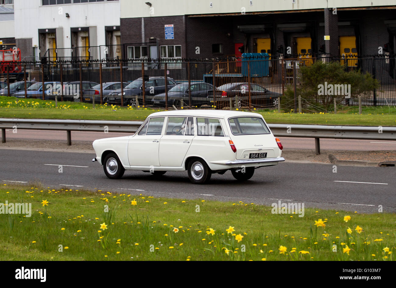 A vintage 1960`s Ford Cortina Deluxe HM estate car travelling along the ...