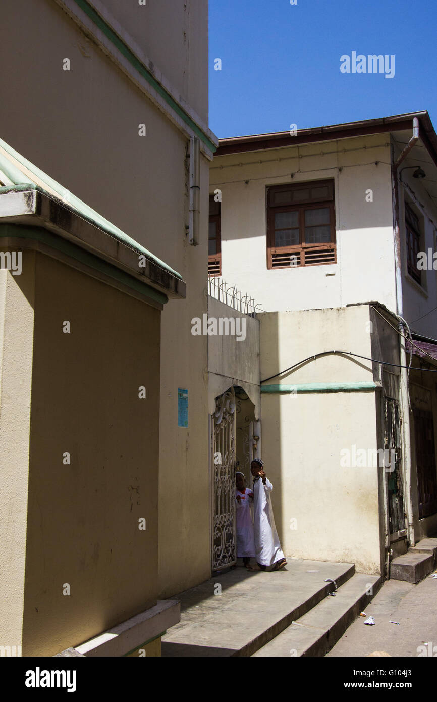 Two Muslim boys enter an Islamic School in a backstreet of Stone Town ...