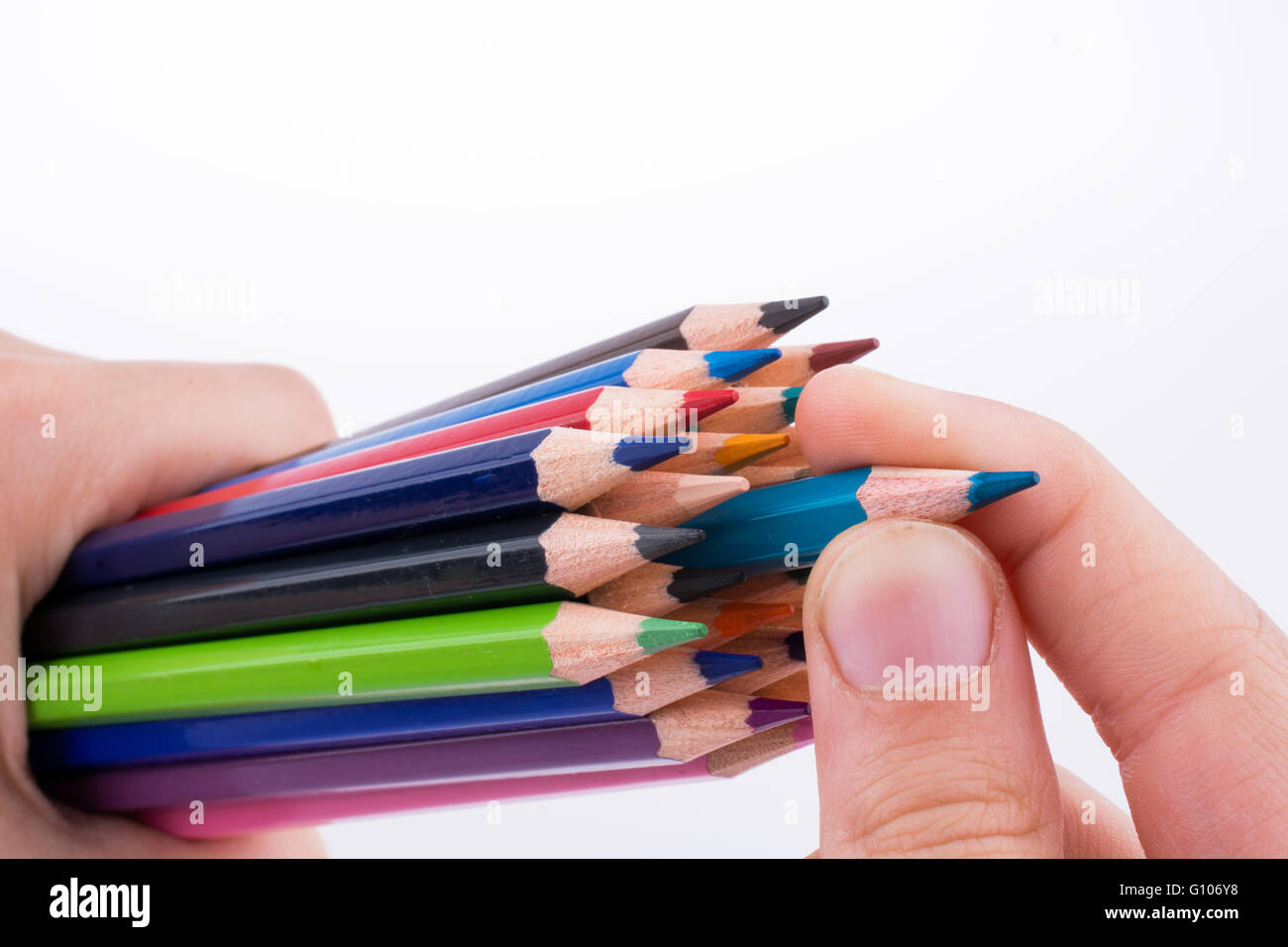 Hand holding color pencils on a white background Stock Photo - Alamy