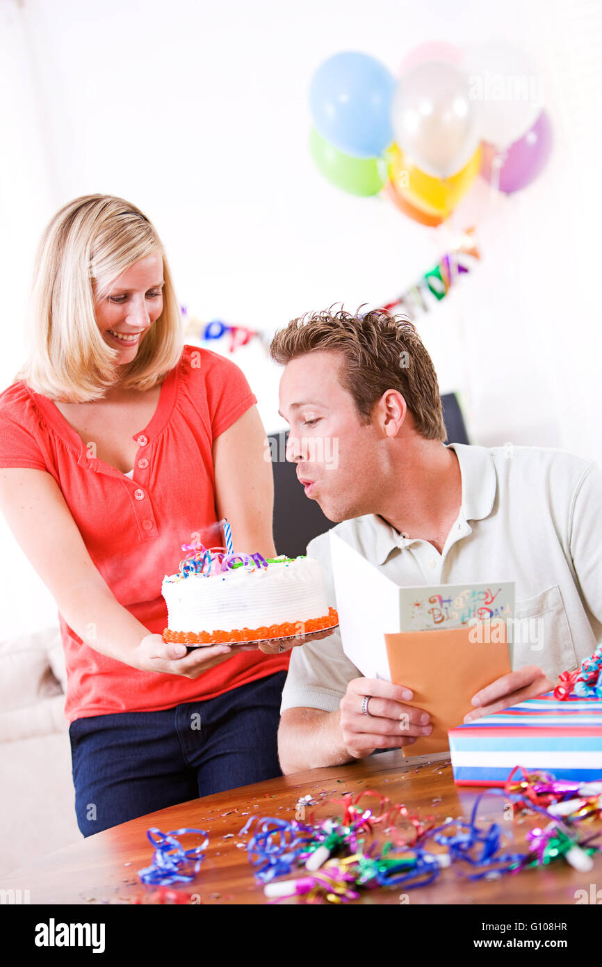 Series with a family celebrating a birthday at home, with balloons and ...