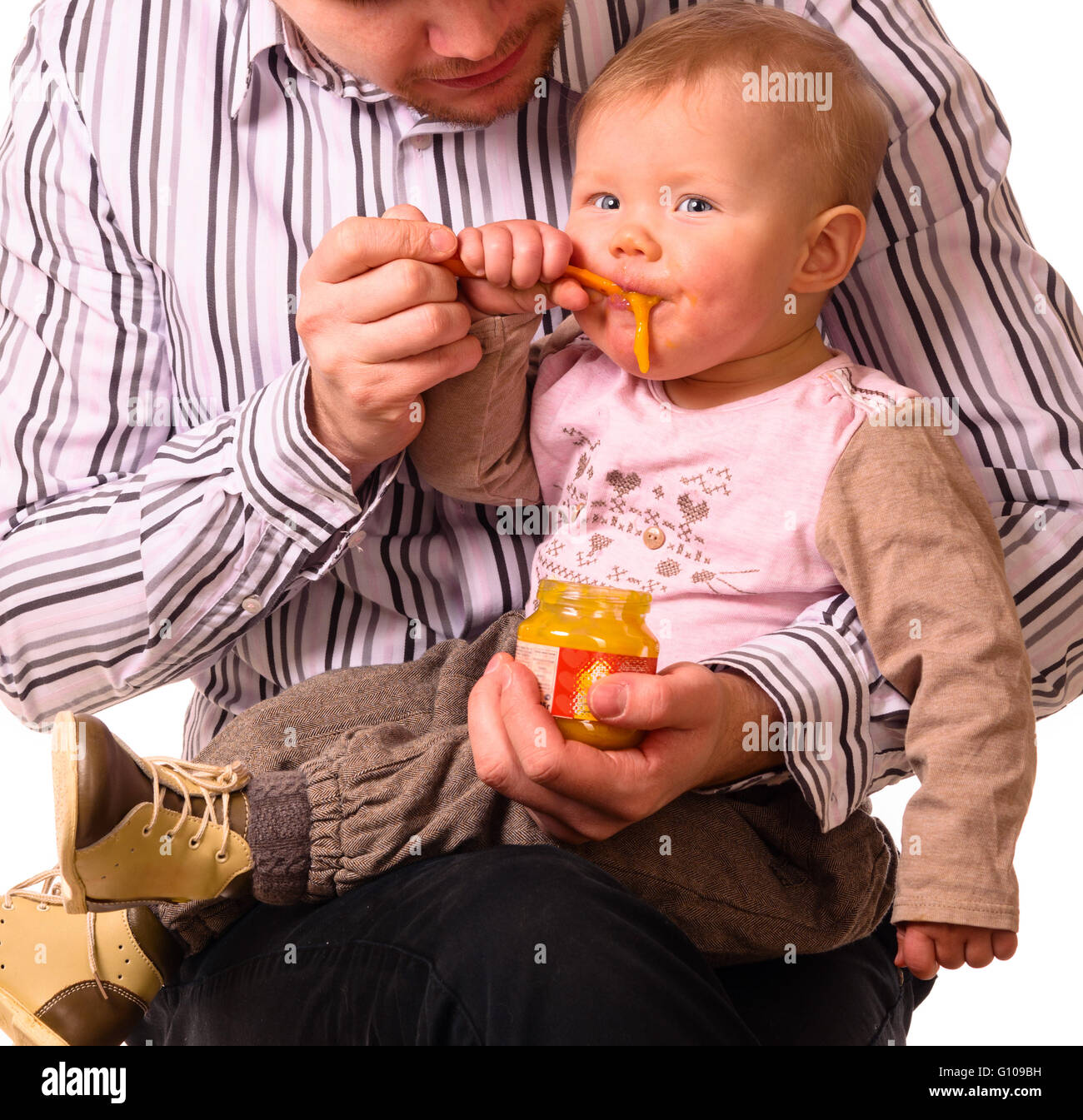 man is feeding his baby Stock Photo - Alamy