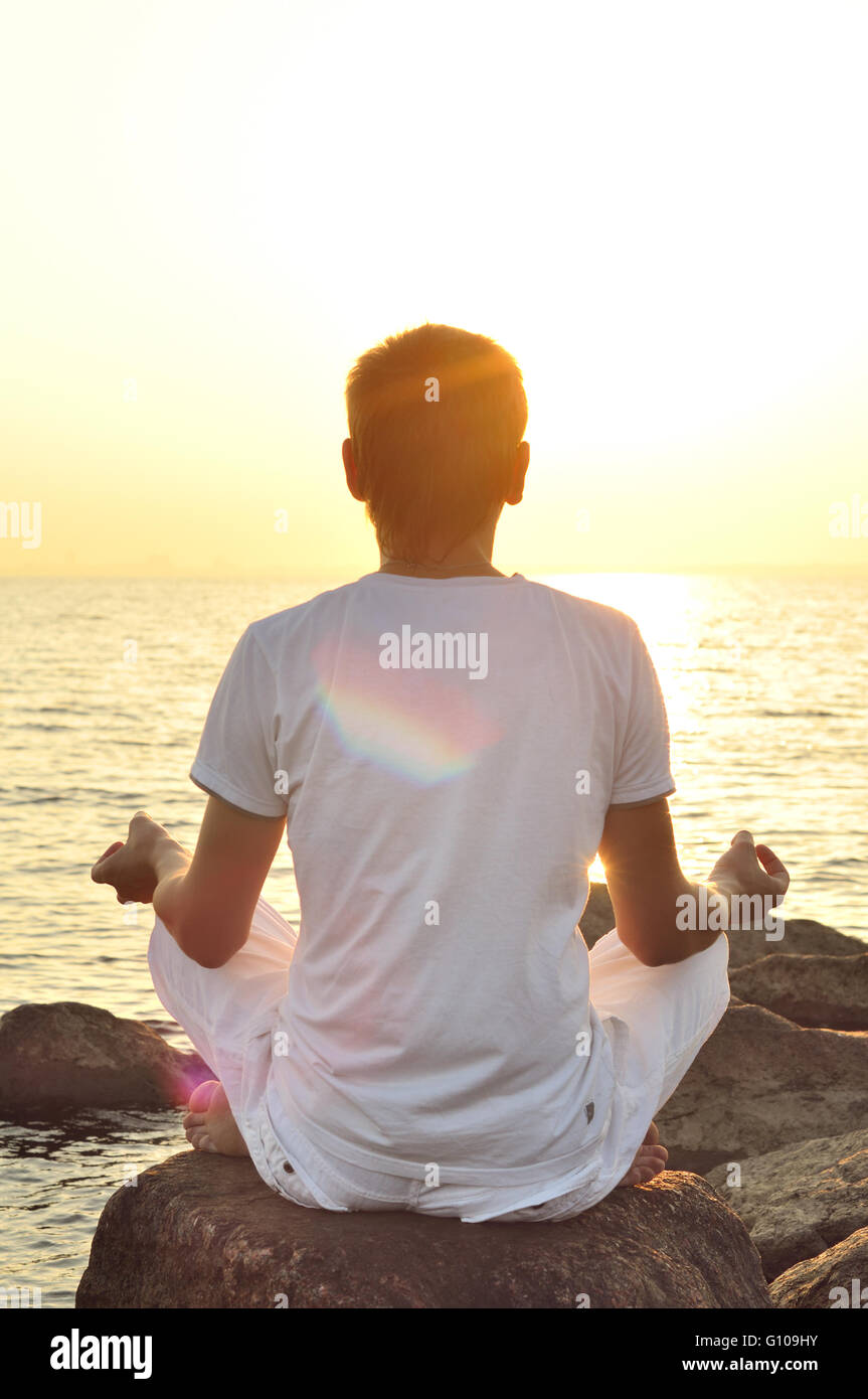 Man is sitting on a stone hi-res stock photography and images - Alamy