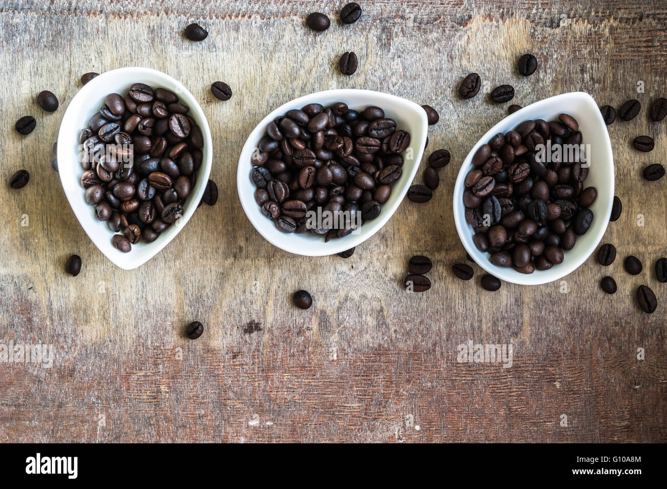 Coffee beans on rustic background Stock Photo - Alamy