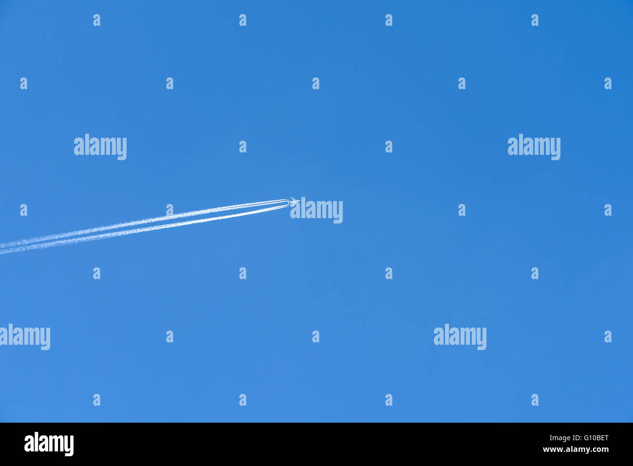 Airplane On Clear Blue Summer Sky Stock Photo - Alamy
