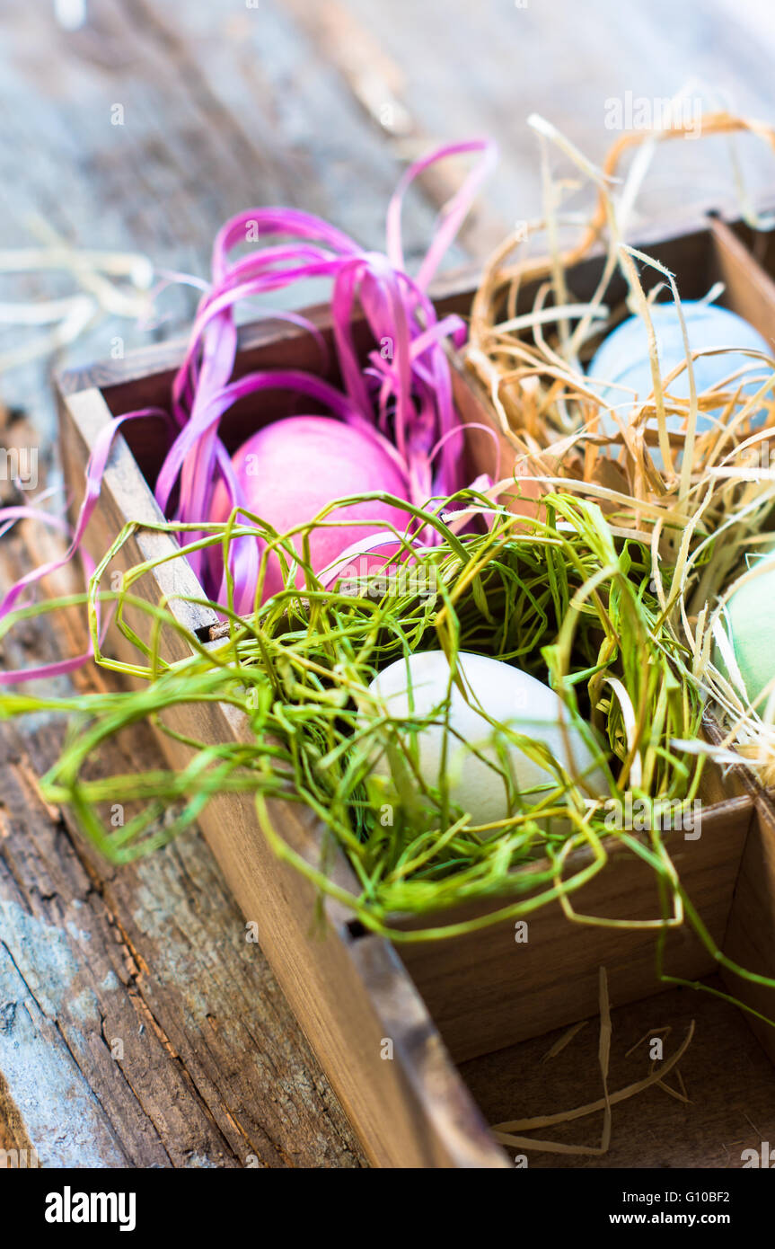 Easter eggs in a vintage box on rustic background Stock Photo - Alamy