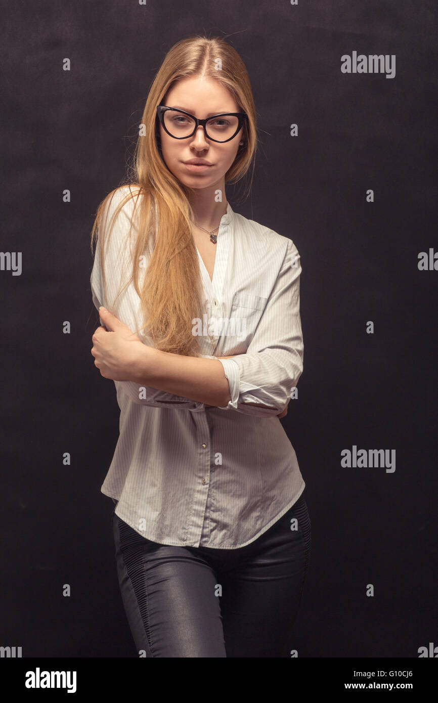 young woman in skeptical pose on black background Stock Photo - Alamy