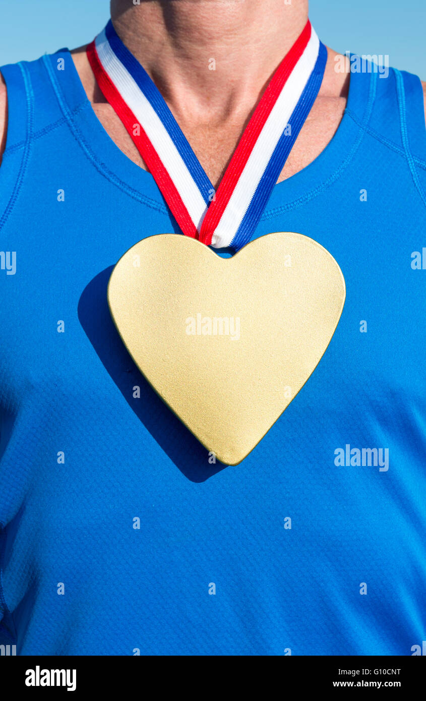 American athlete standing with gold medal in the shape of a heart ...