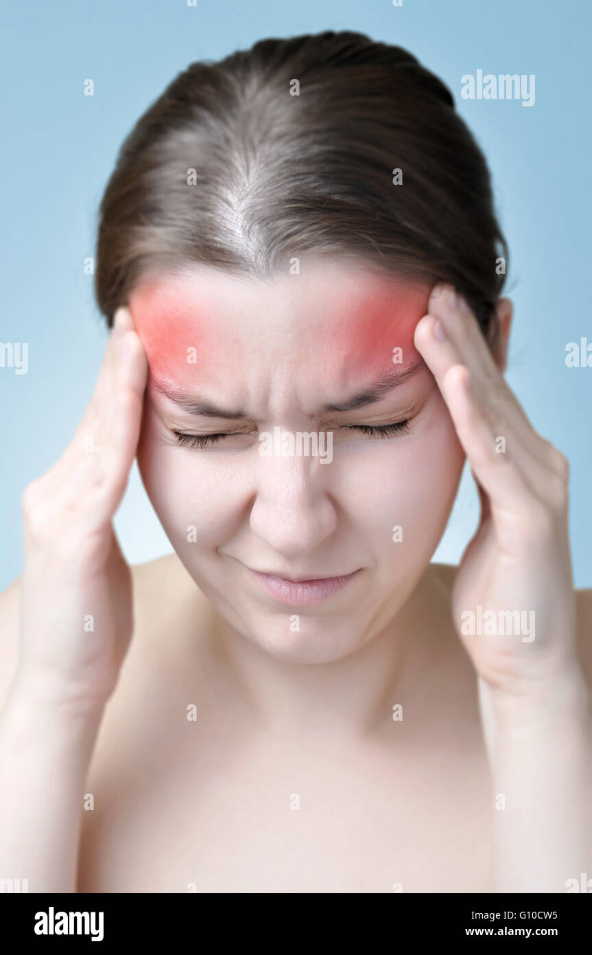 Young woman touching her head Stock Photo - Alamy