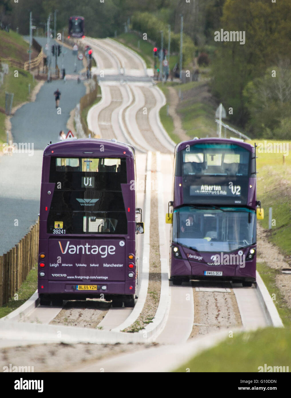 Two double decker buses passing on new concrete guided busway Stock ...