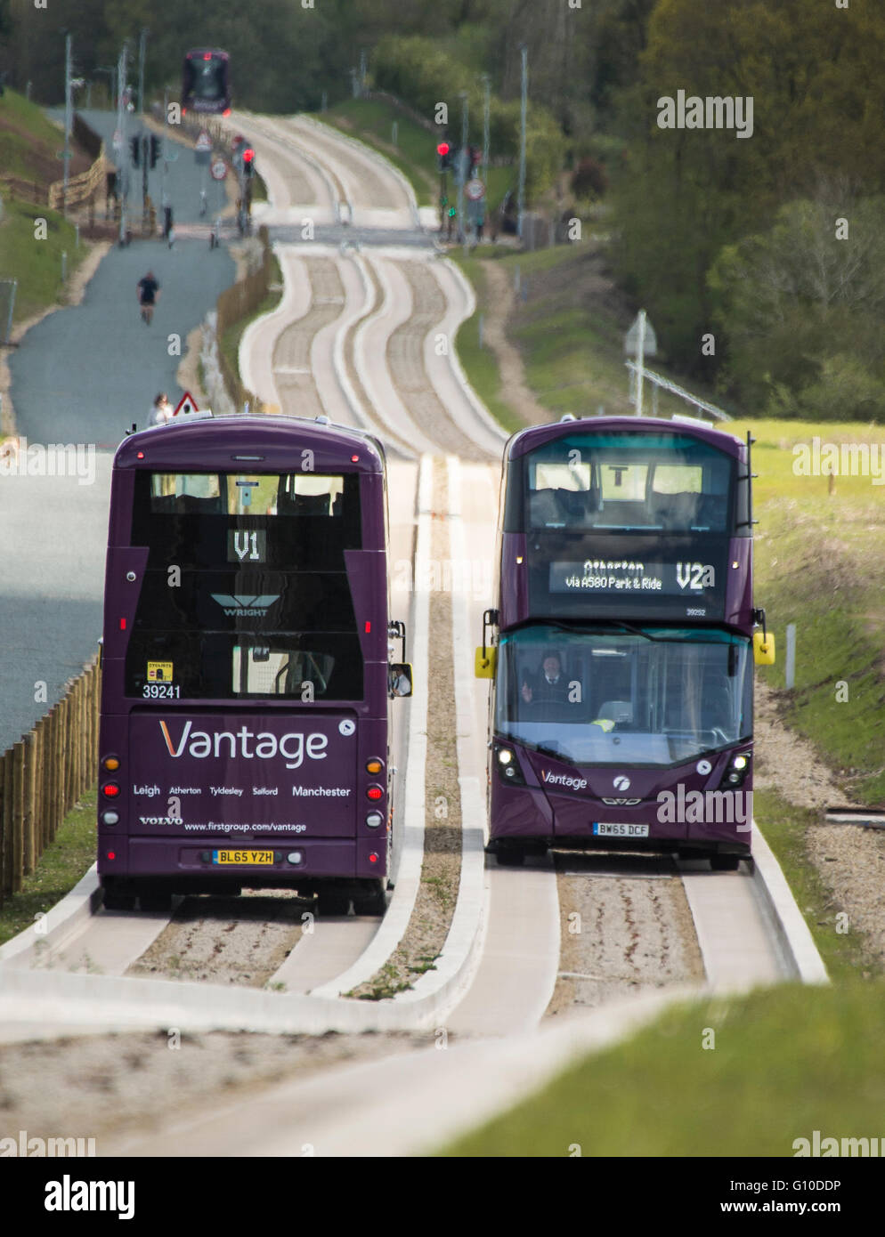 Two double decker buses passing on new concrete guided busway Stock ...