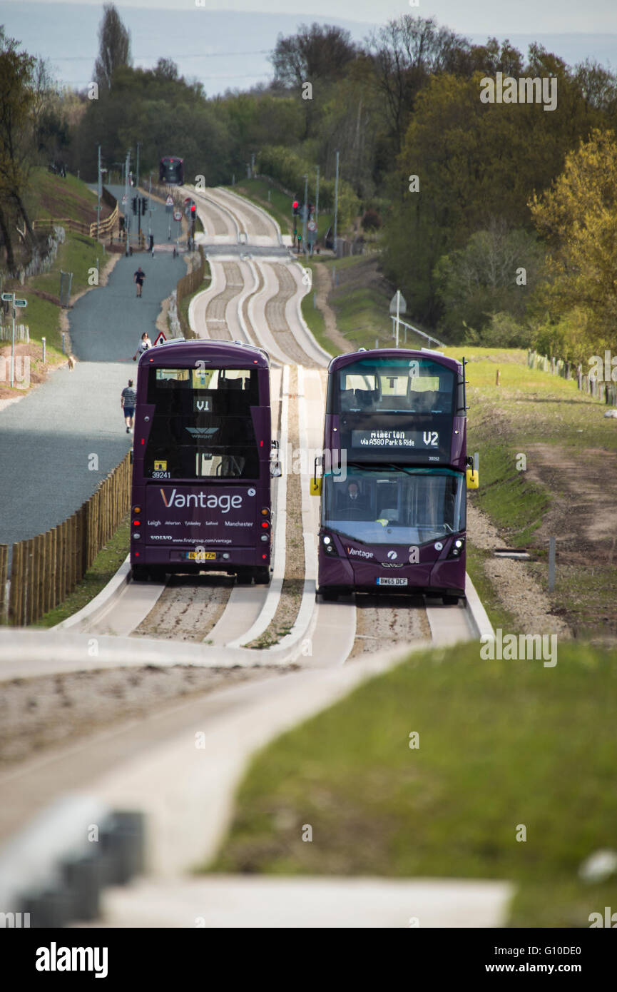 Two double decker buses passing on new concrete guided busway Stock ...