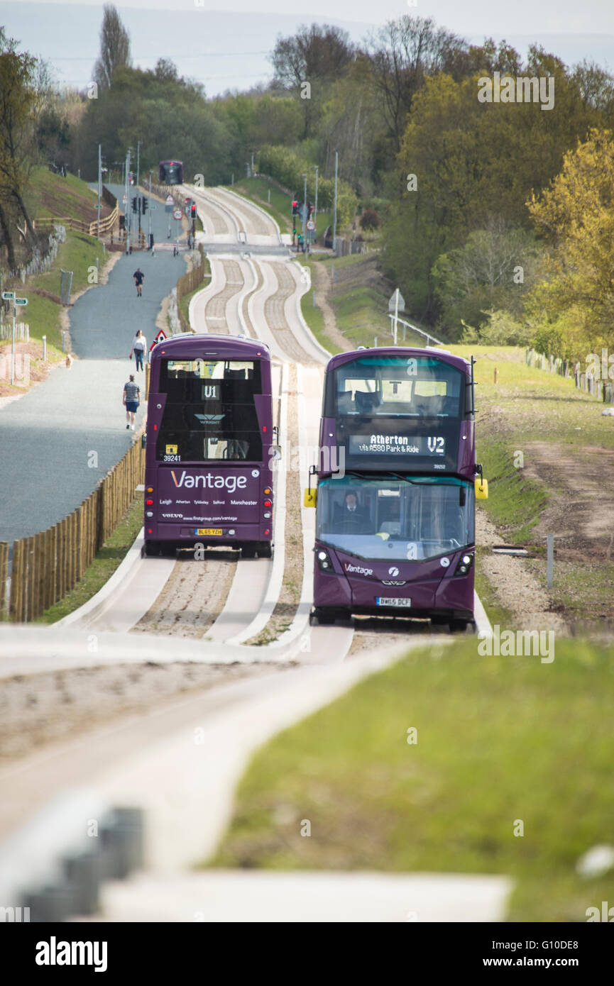 Two double decker buses passing on new concrete guided busway Stock ...