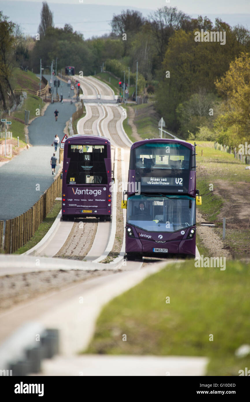 Two double decker buses passing on new concrete guided busway Stock ...