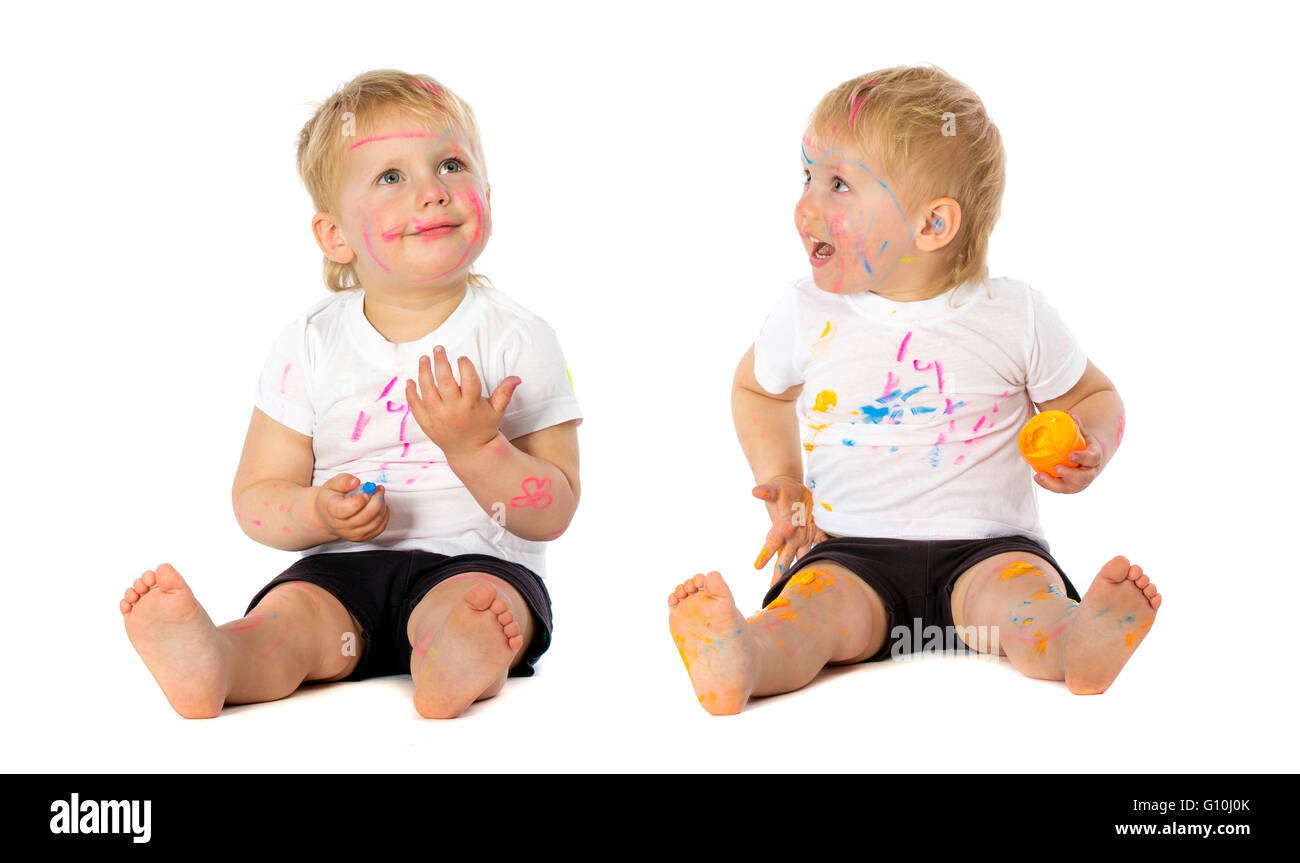 Twins brothers playing with paint, isolated on white Stock Photo - Alamy