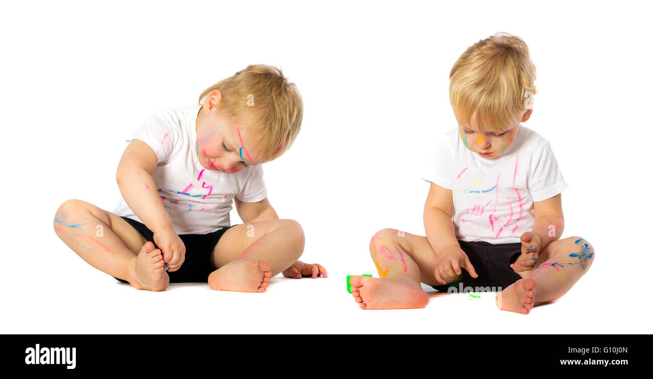 Twins brothers playing with paint, isolated on white Stock Photo - Alamy