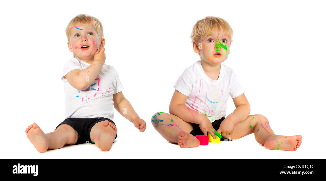 Twins brothers playing with paint, isolated on white Stock Photo - Alamy