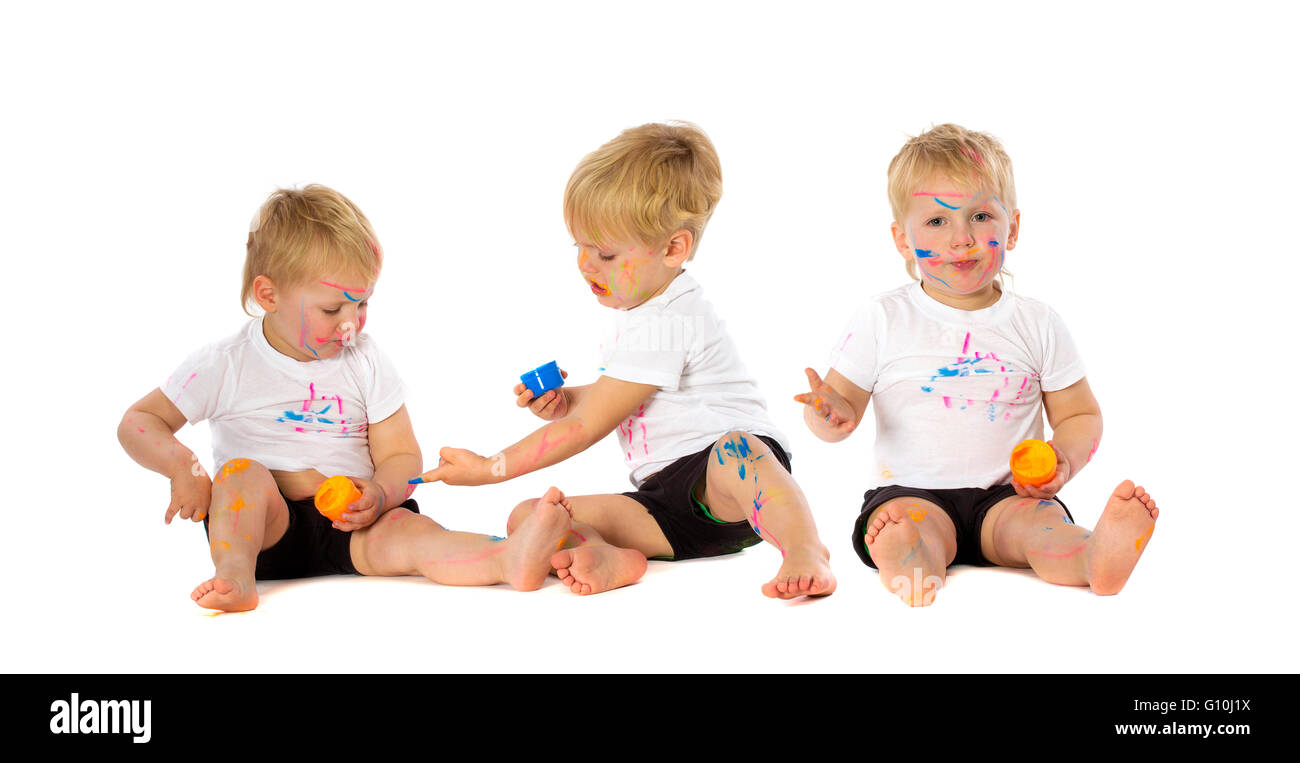Twins brothers playing with paint, isolated on white Stock Photo - Alamy