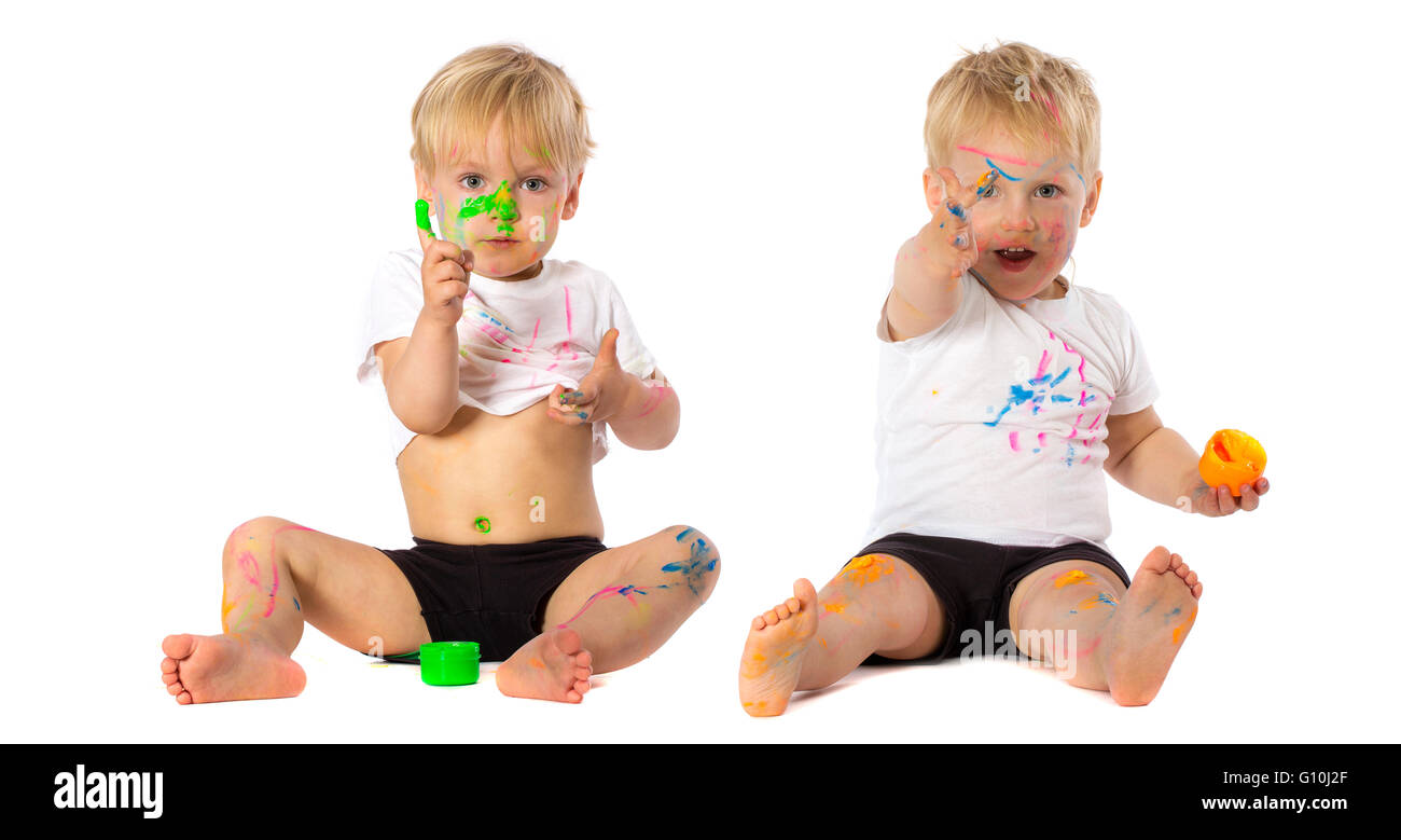 Twins brothers playing with paint, isolated on white Stock Photo - Alamy