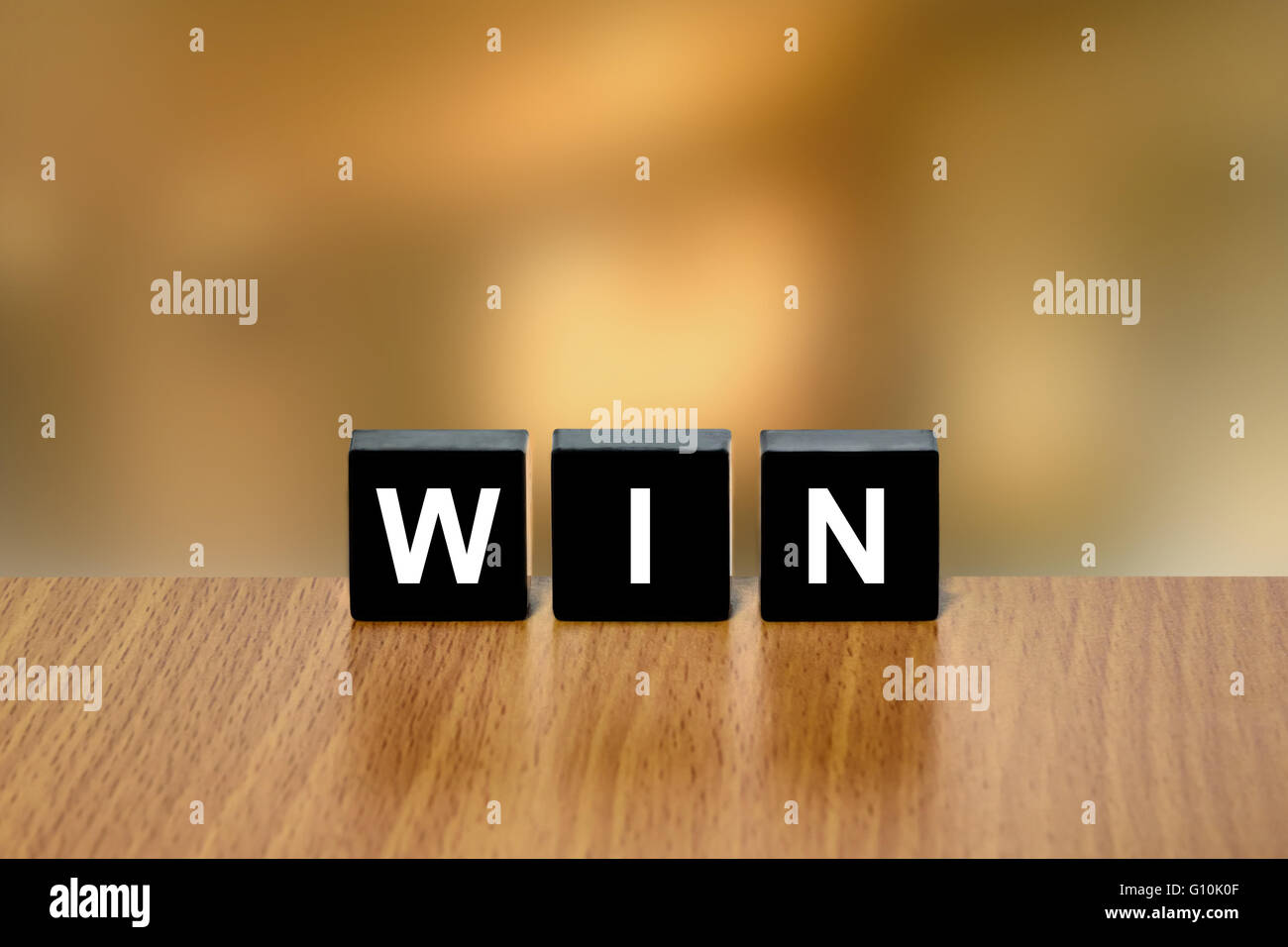 win, winner on black block with blurred background Stock Photo - Alamy