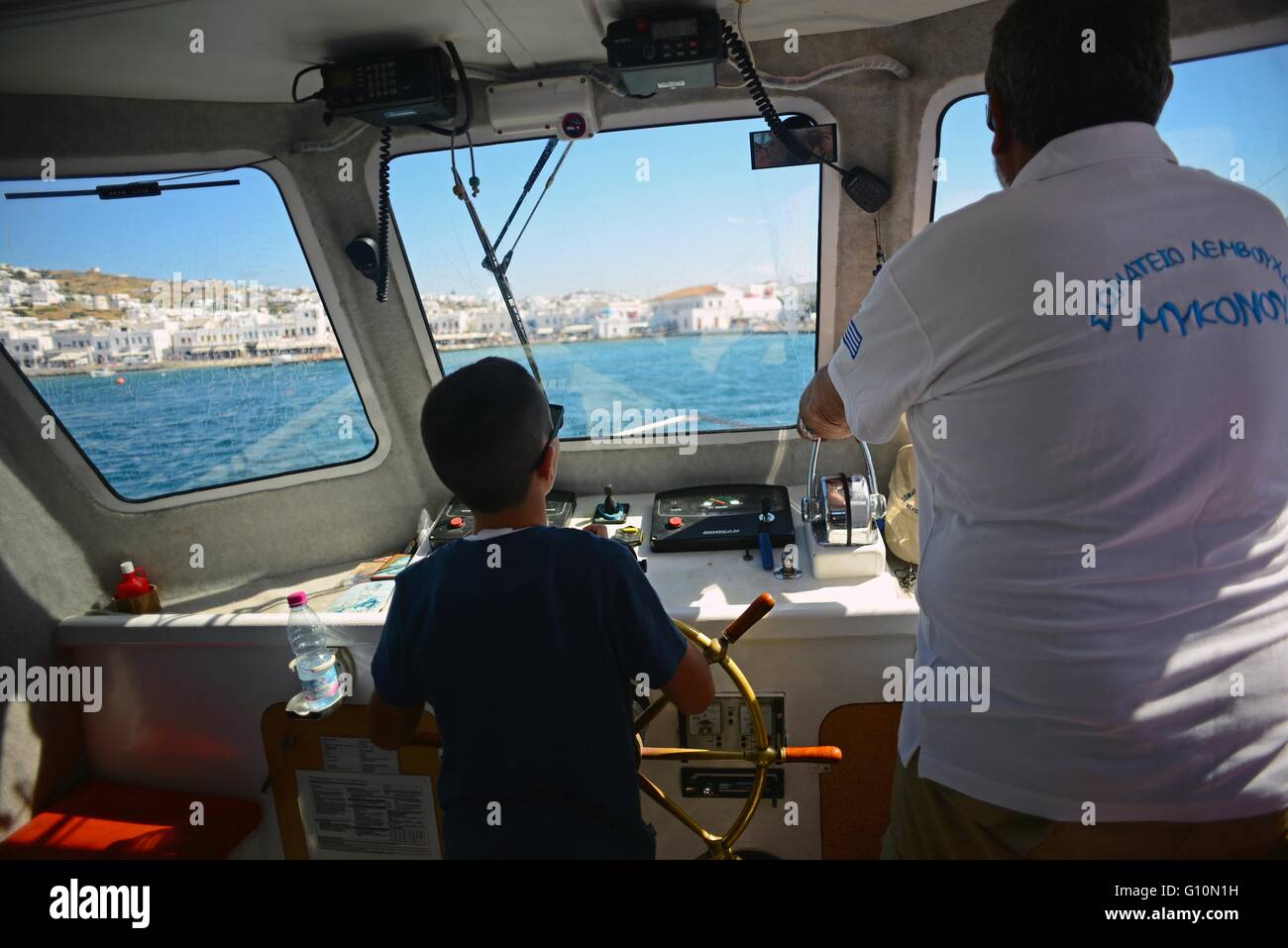Boy driving boat hi-res stock photography and images - Alamy