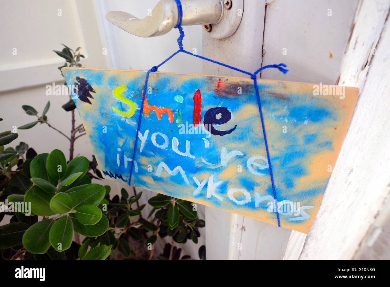 Sign reads "Smile you¥re in Mykonos", Mykonos, Greece Stock Photo - Alamy