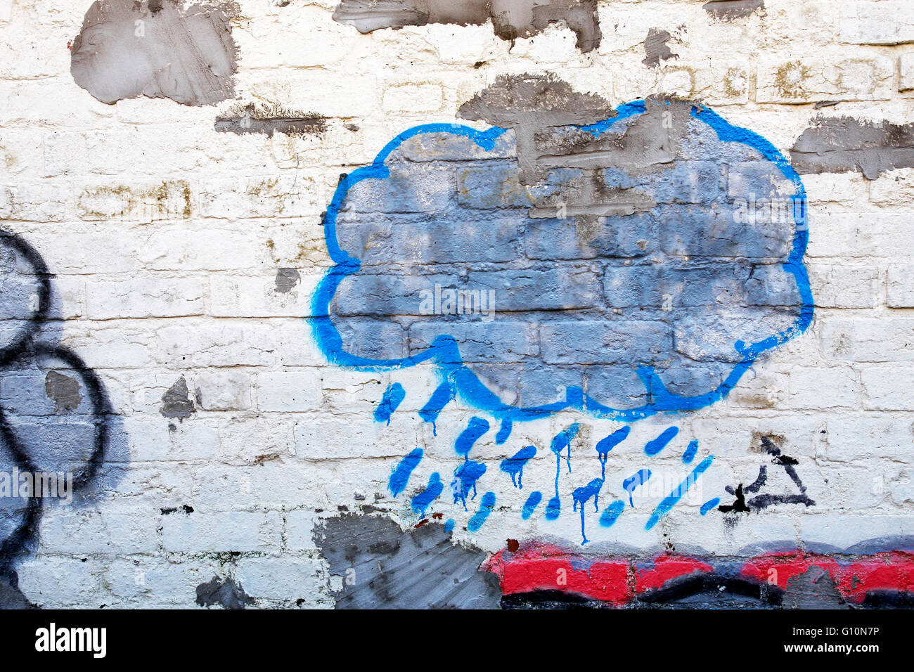 Blue cloud graffiti on a whitewashed brick wall Stock Photo - Alamy