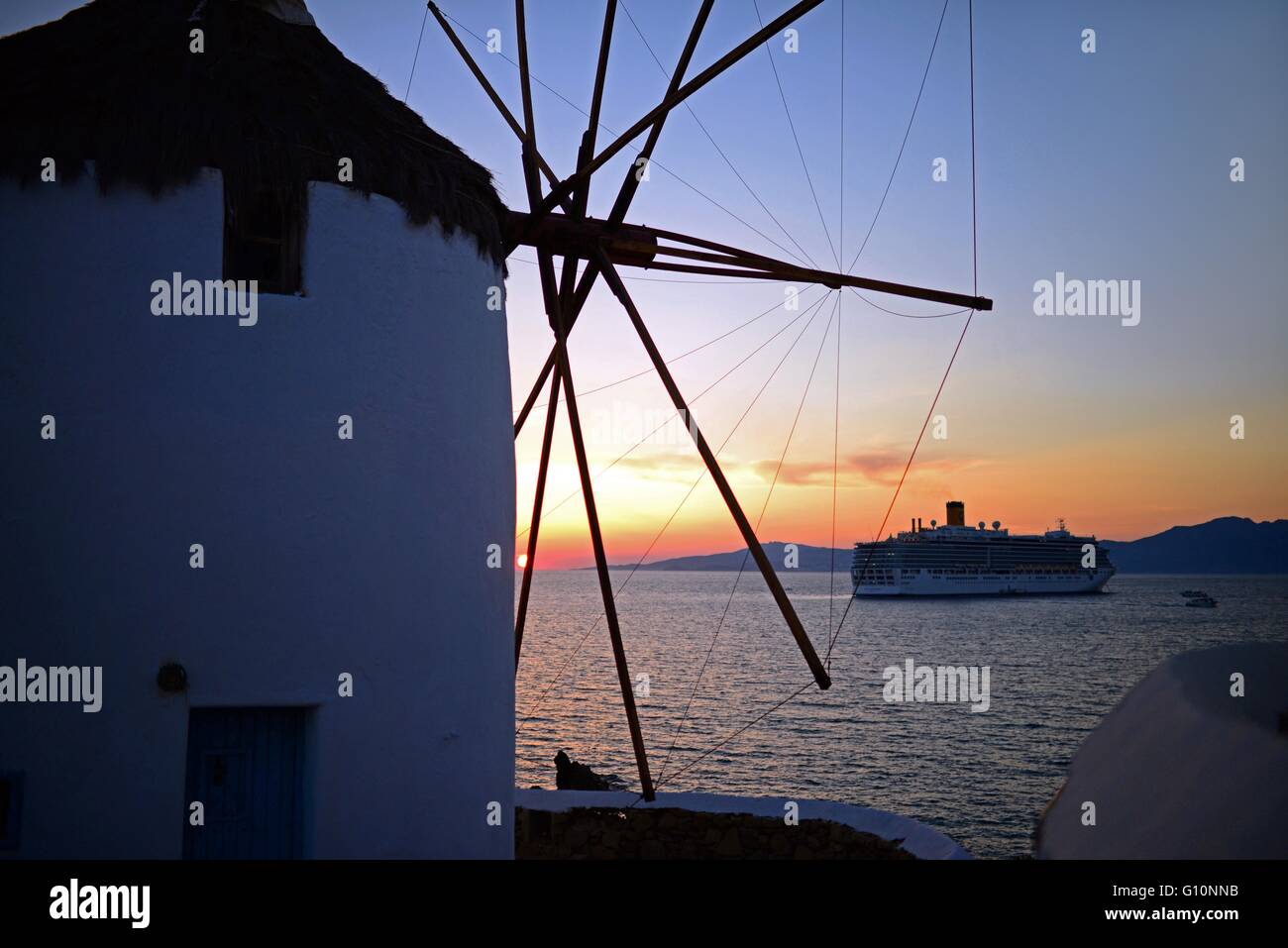 Traditional windmills (Kato Milli) at sunset in Mykonos town, Greece ...