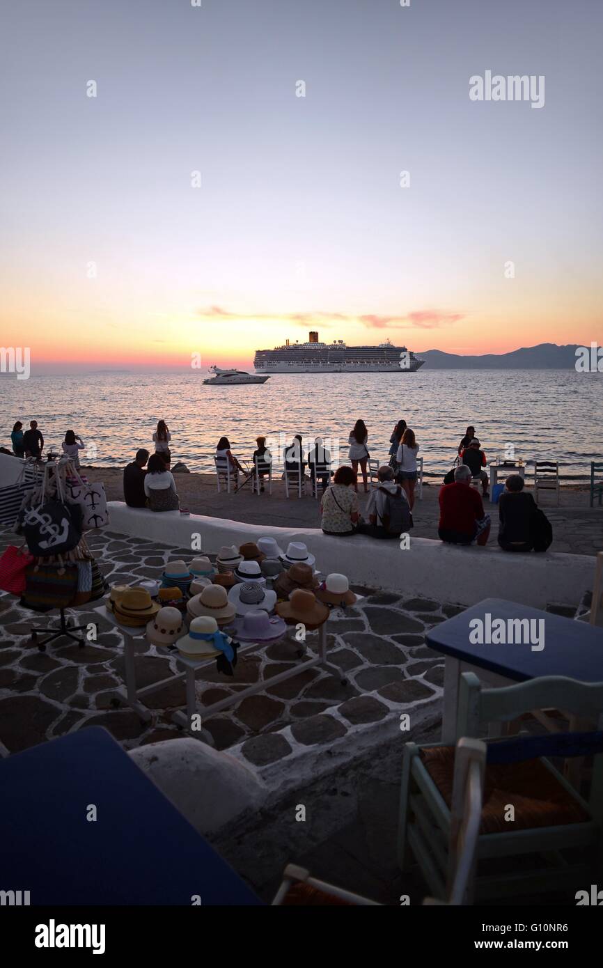 People enjoying views of Mykonos town at sunset, Greece Stock Photo - Alamy