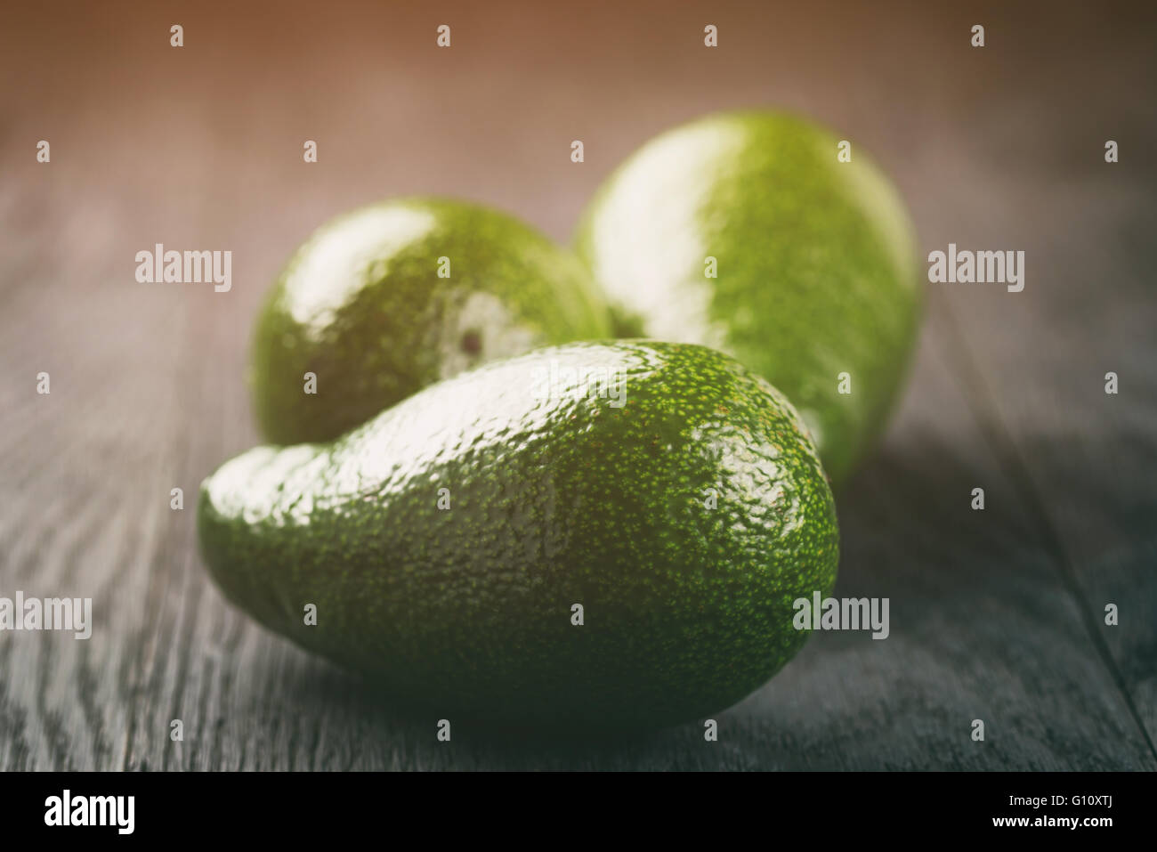 ripe green avocados on wood table Stock Photo - Alamy