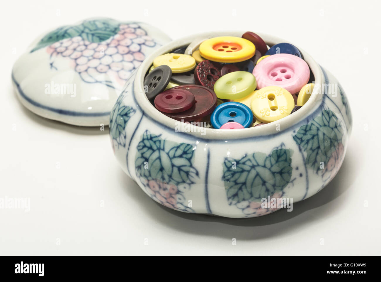 decorative glass container of clothing buttons Stock Photo - Alamy