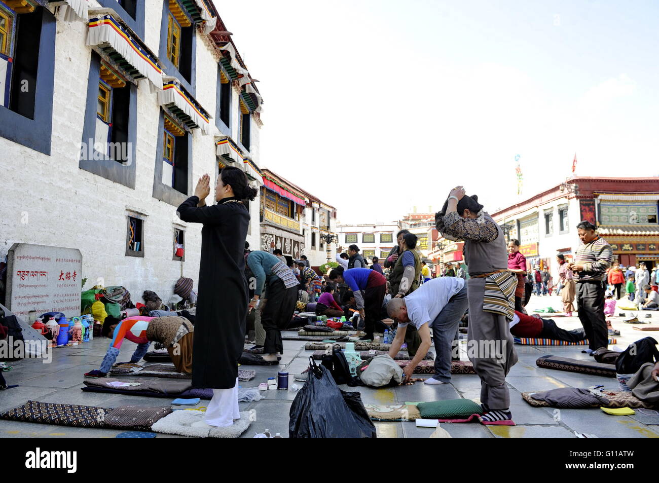 Lhasa. 7th May, 2016. Pilgrims pray at the entrance of the Jokhang ...