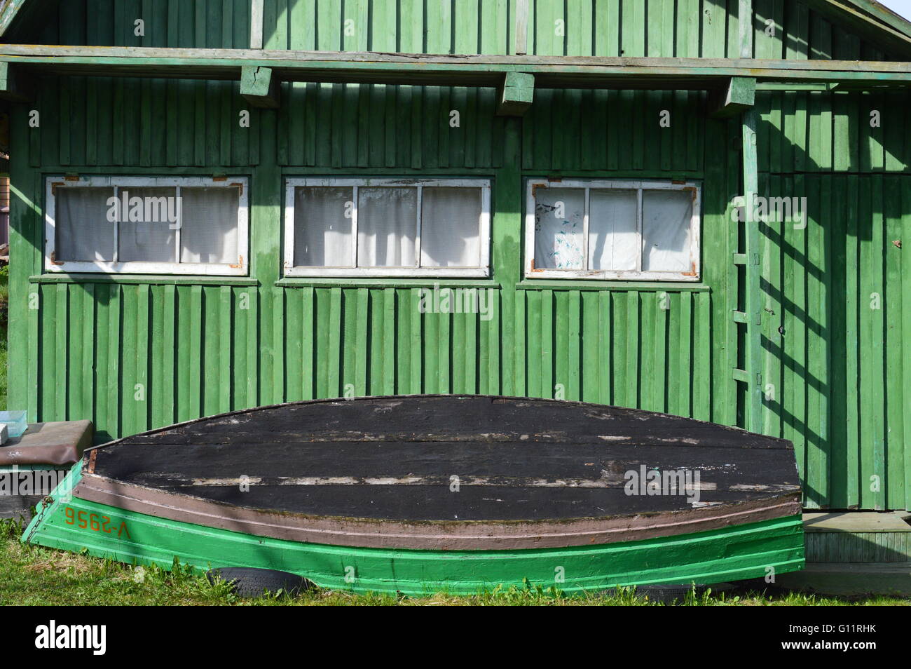 Green boat, green building Stock Photo - Alamy