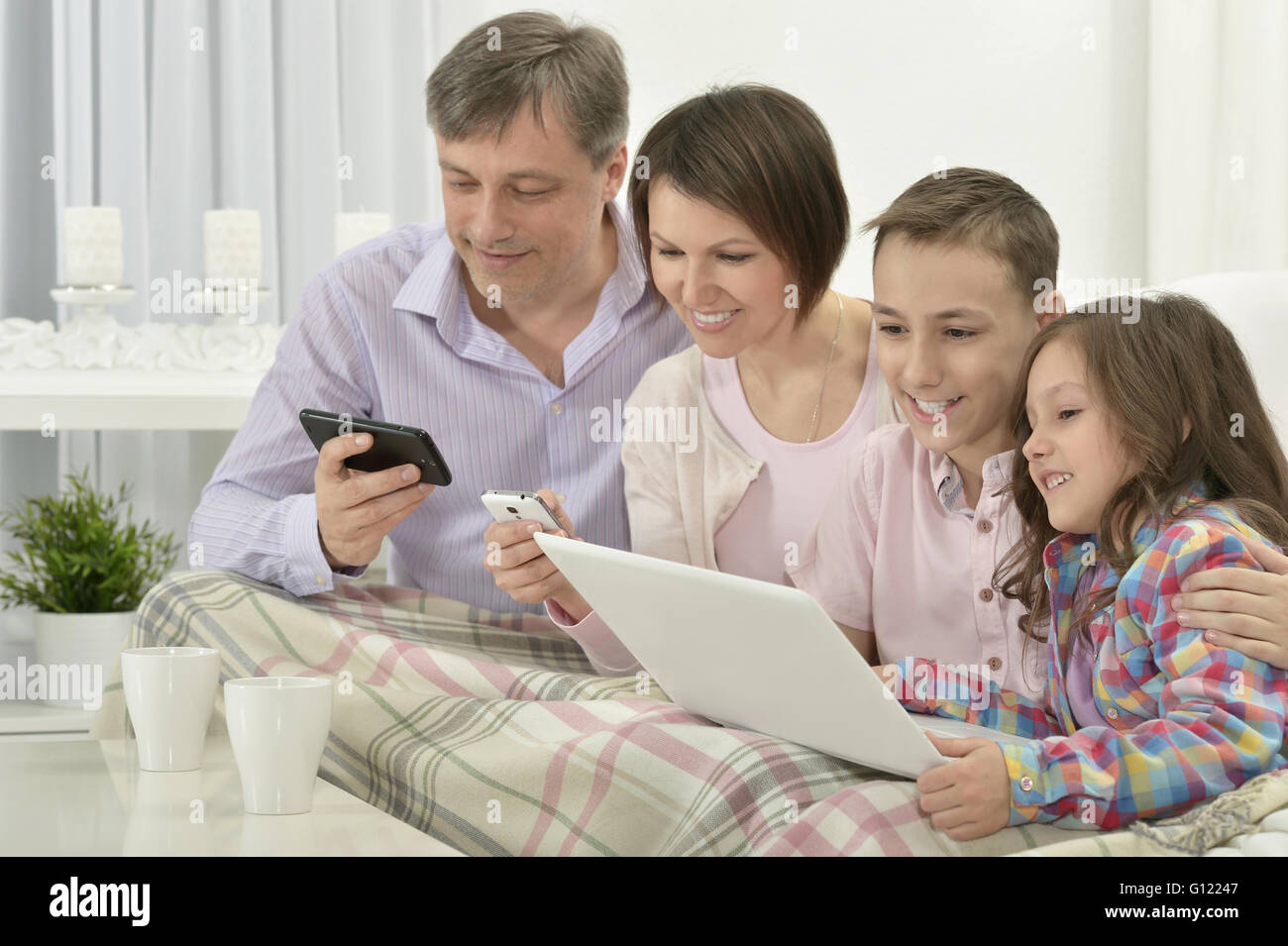 Happy family with laptop Stock Photo - Alamy