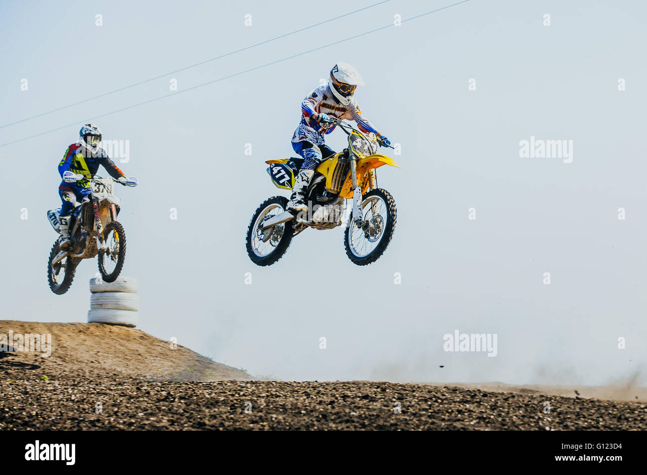 two riders on motorcycles jump from mountain and fly during Cup of ...