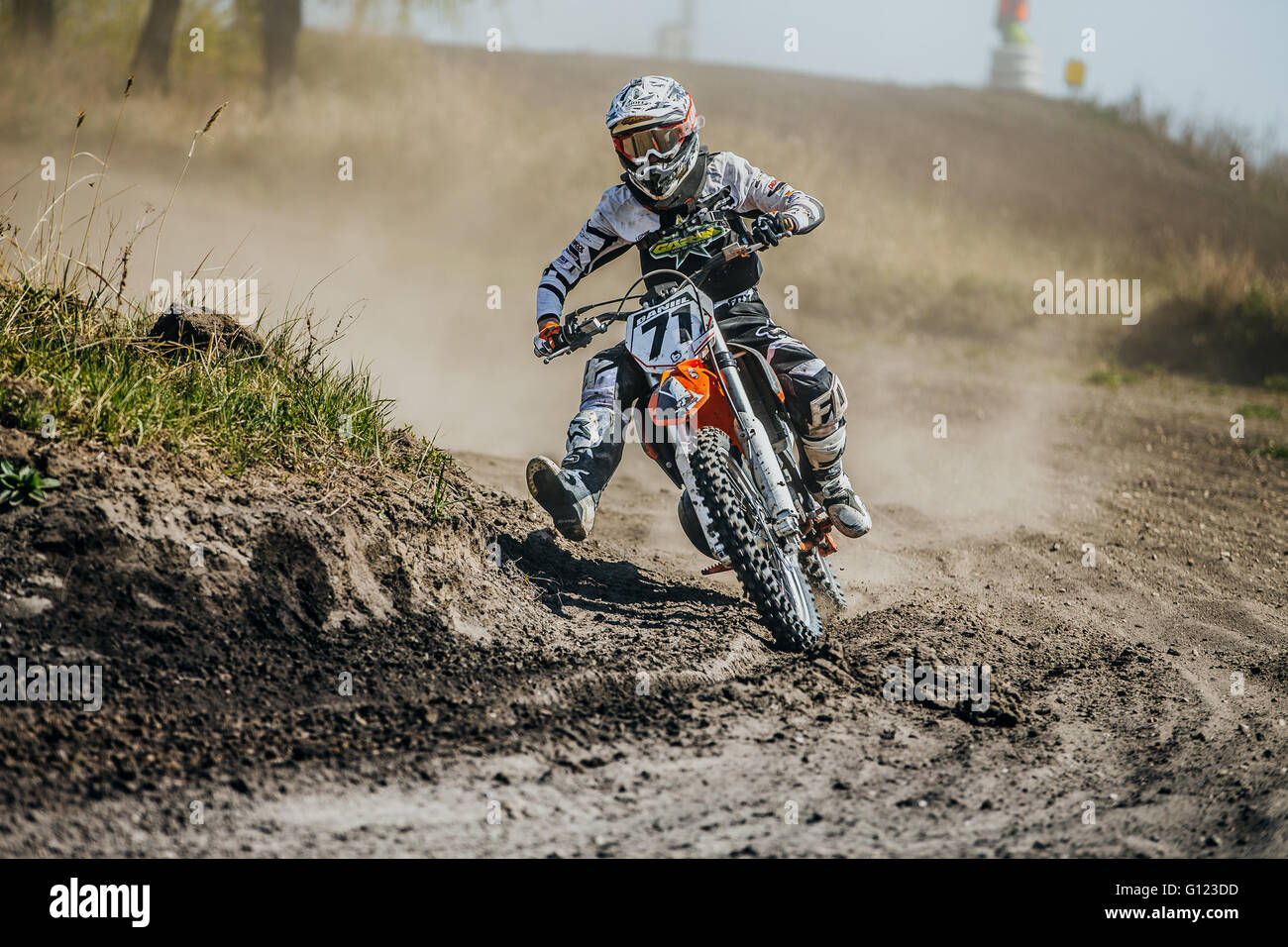 racer on a motorcycle turns on a dusty race track during Cup of Urals ...