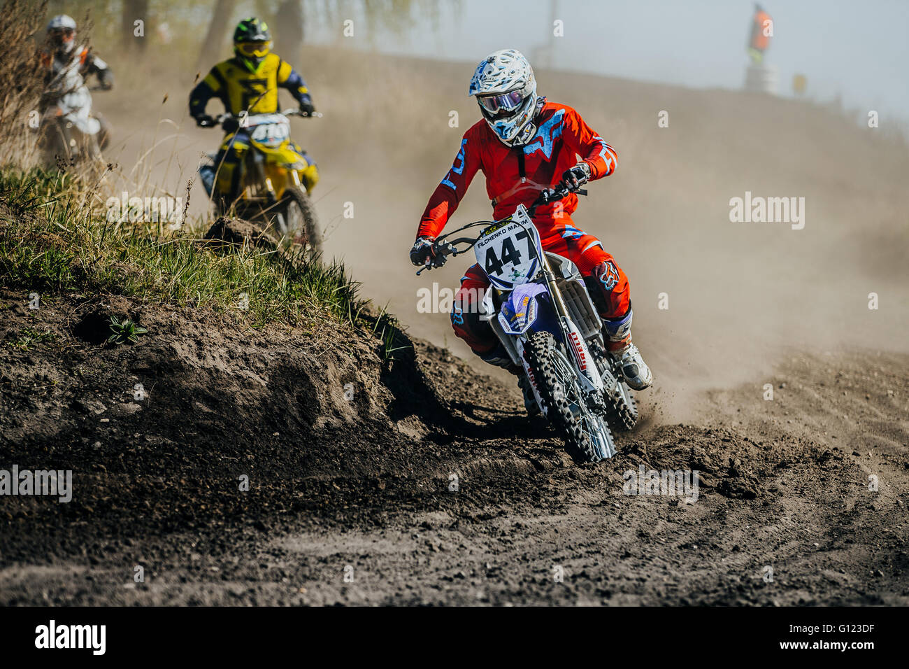 group racer on a motorcycle turns on a dusty race track during Cup of ...