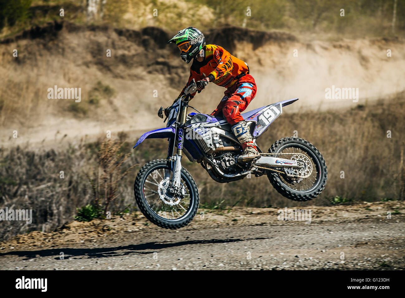 racer on a motorcycle jump over race track during Cup of Urals ...
