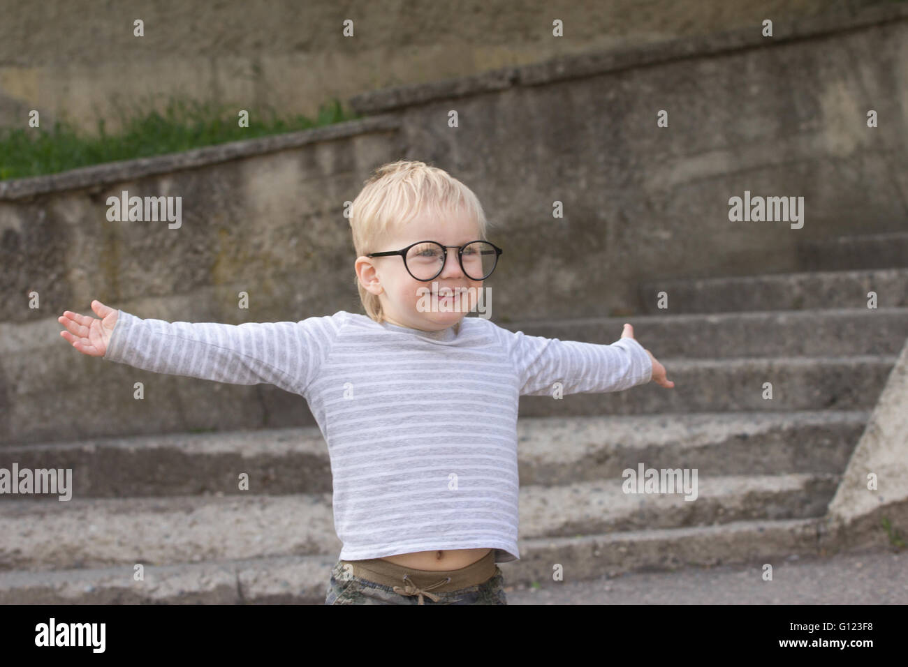 Happy child with falling down glasses, outdoors Stock Photo - Alamy