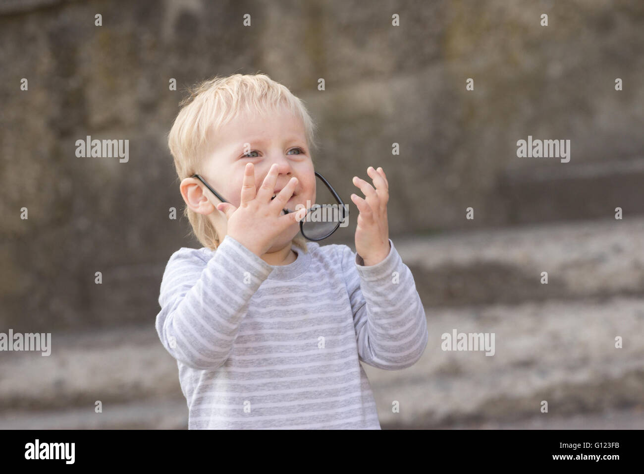 Happy child with falling down glasses, outdoors Stock Photo - Alamy
