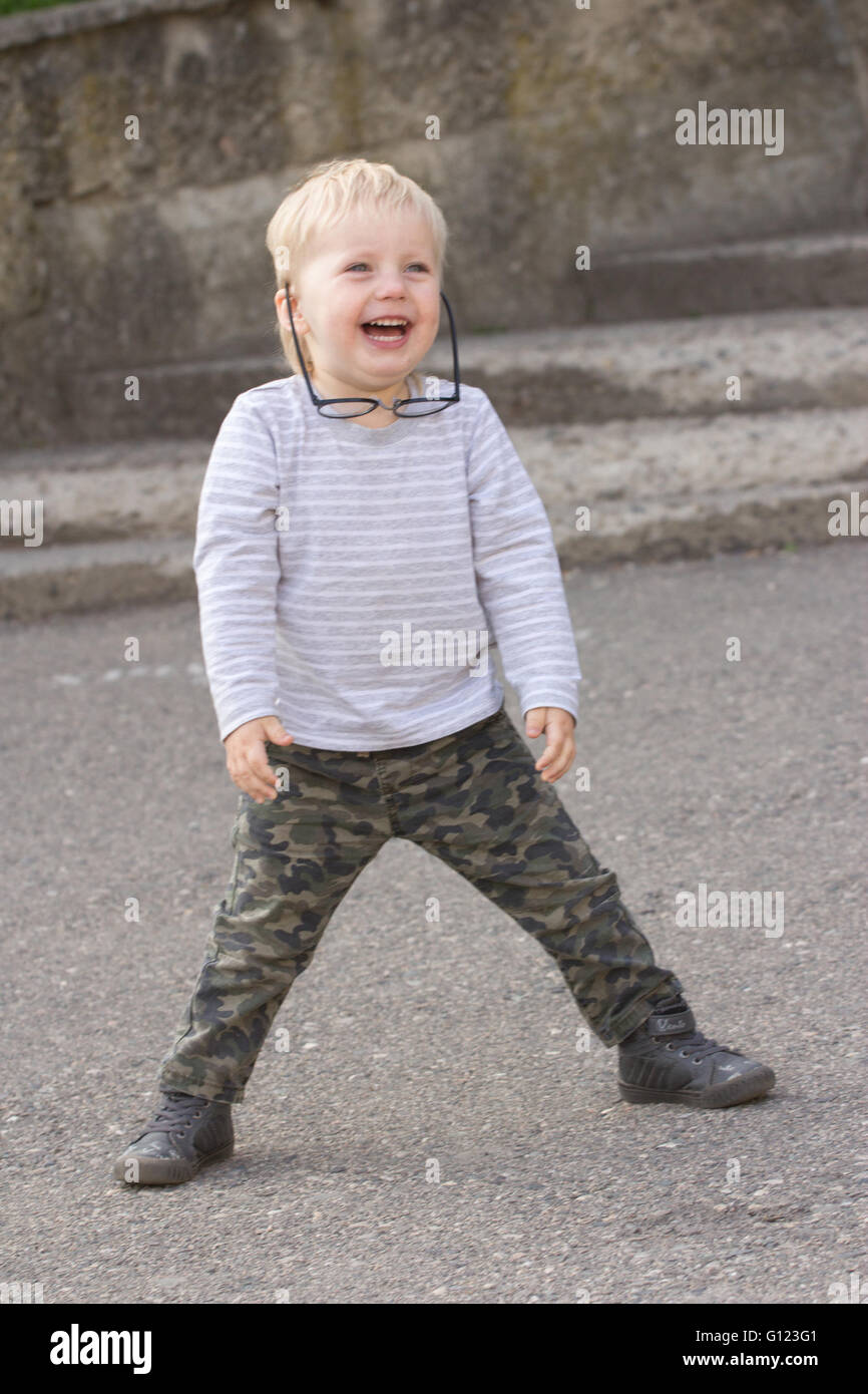 Happy child with falling down glasses hi-res stock photography and ...