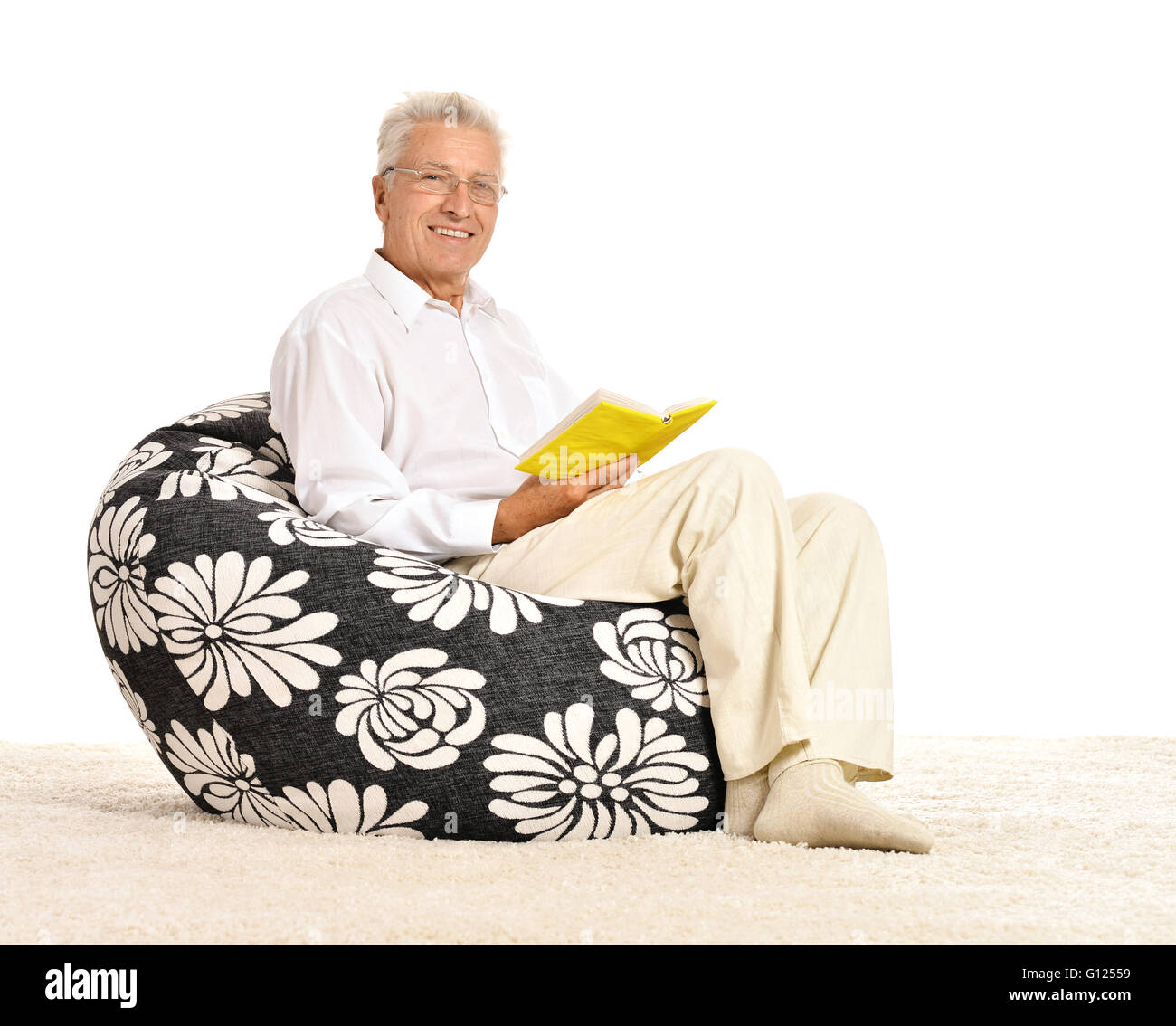 Senior man sitting Stock Photo - Alamy