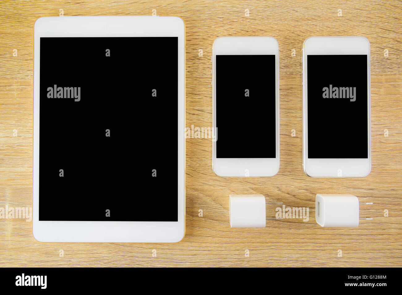 Smartphone and tablet with black screen on wooden table background ...