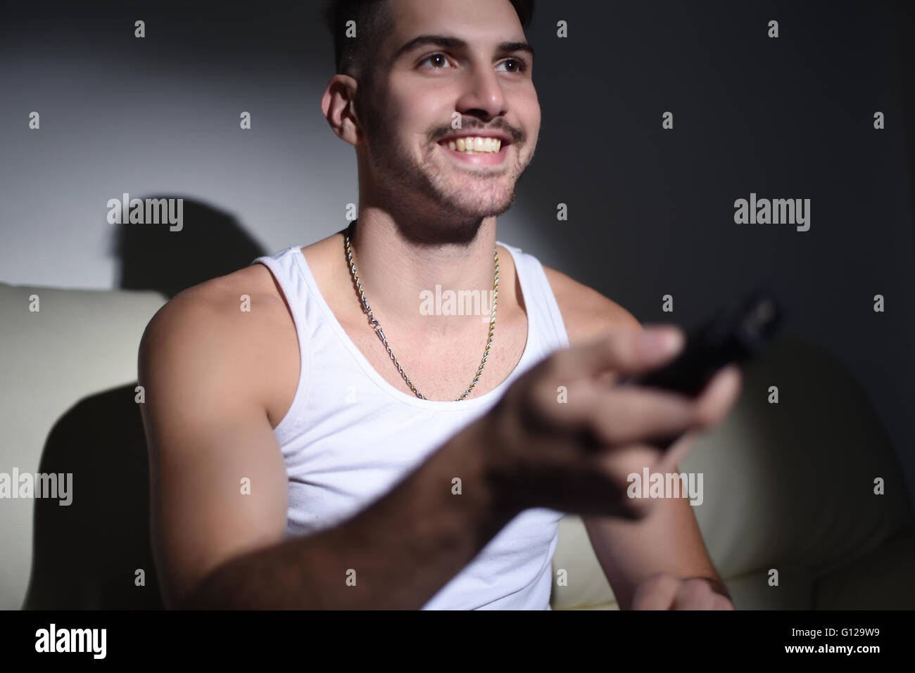 Close up to handsome young man watching movies. Indoor Stock Photo - Alamy