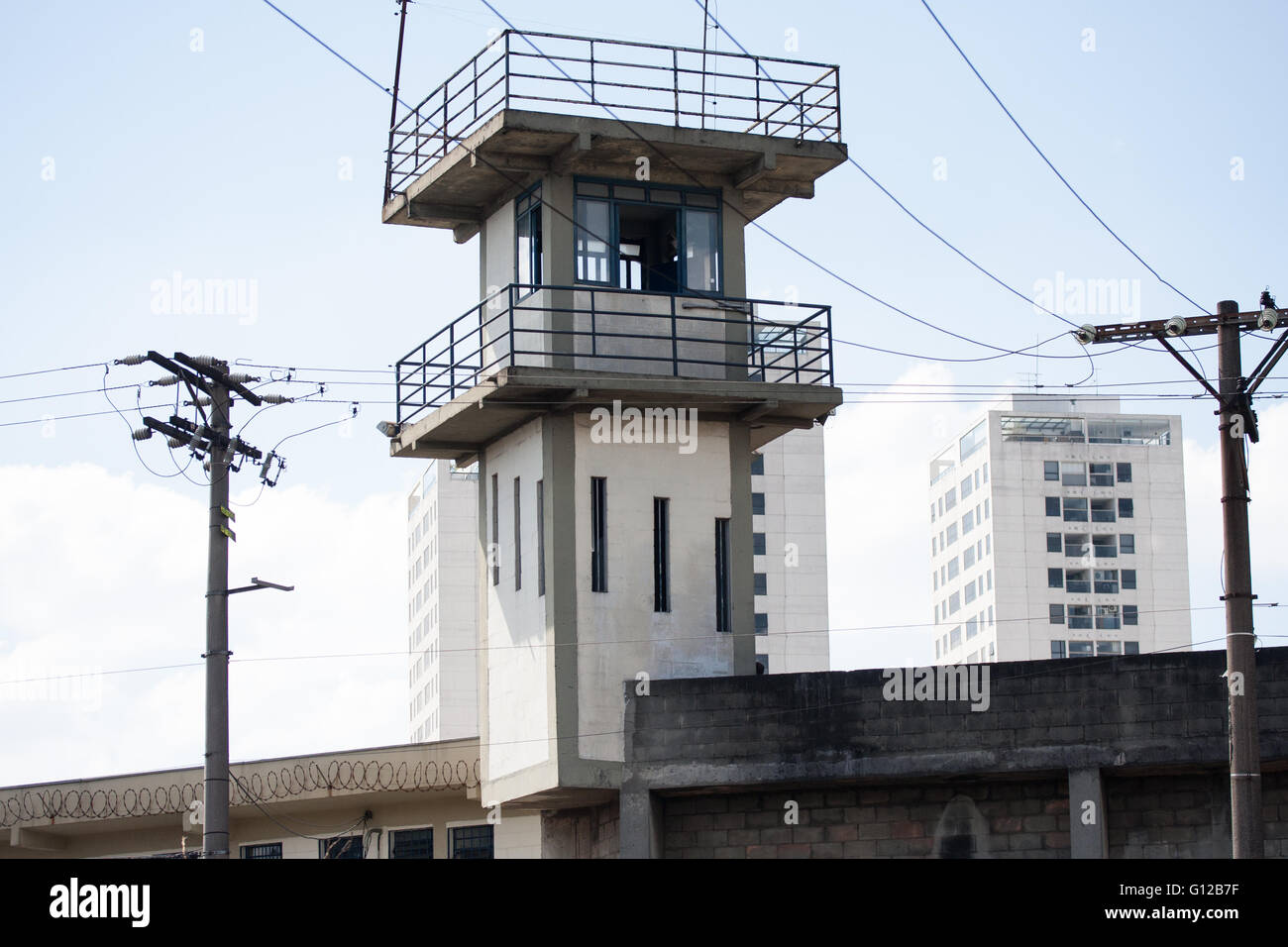 Prison security tower and residential building with blue sky and white ...
