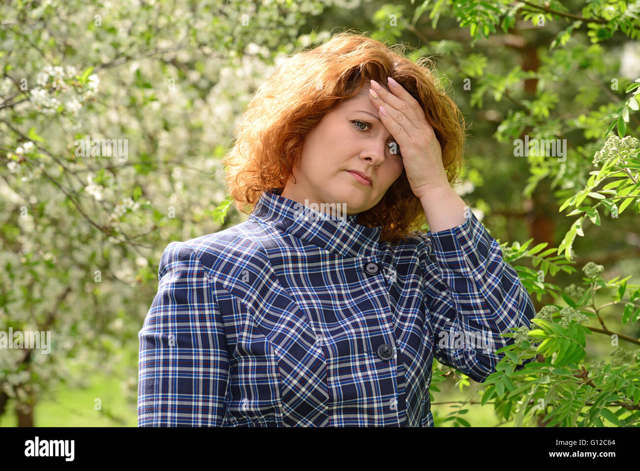 woman with a headache on nature of the spring Stock Photo - Alamy