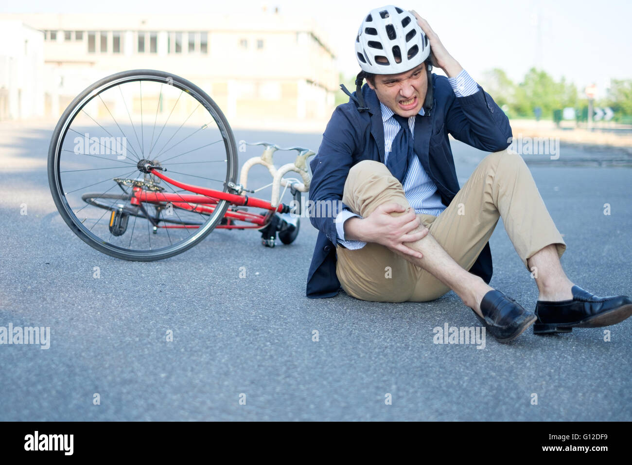 aching man after bicycle accident on the asphalt Stock Photo - Alamy