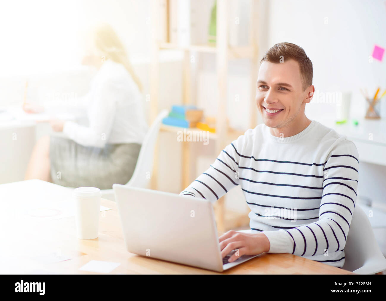 Positive guy working on the laptop Stock Photo - Alamy