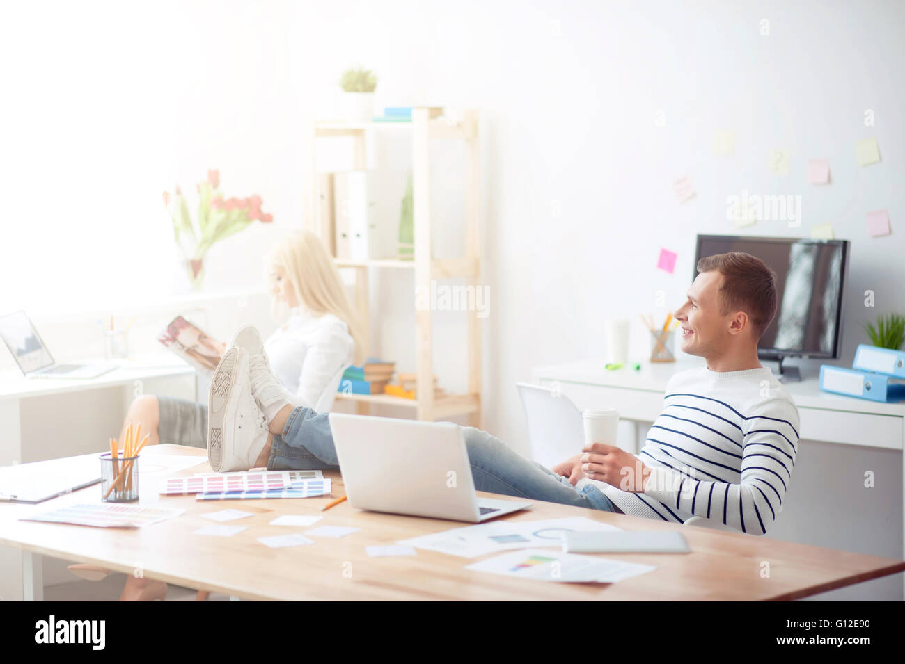 Positive guy resting at work Stock Photo - Alamy