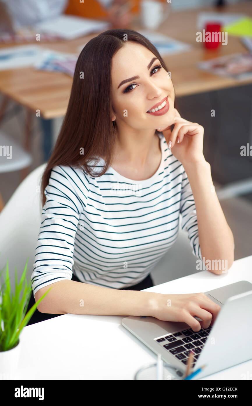 Positive woman working in the office Stock Photo - Alamy