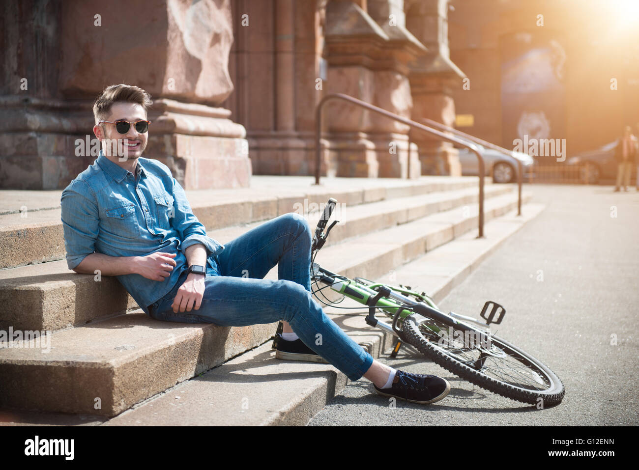 Positive guy resting on the footsteps Stock Photo - Alamy